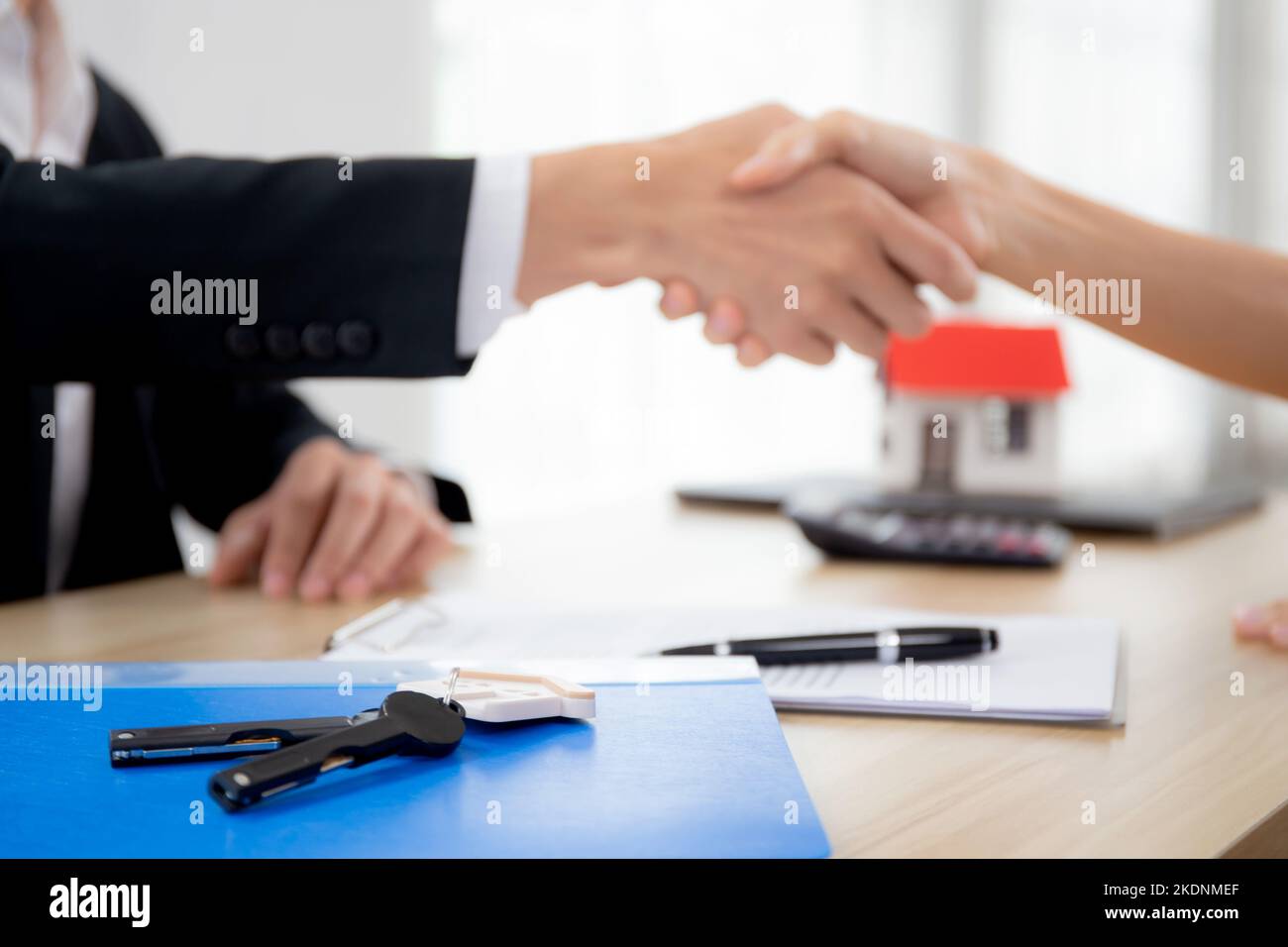 Closeup hands of real estate agent and customer handshake together ...