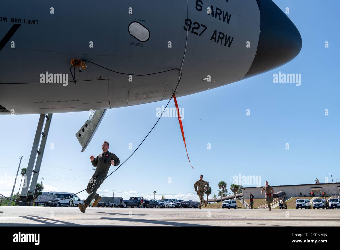Airmen assigned to the 6th Air Refueling Wing run toward a KC-135 ...