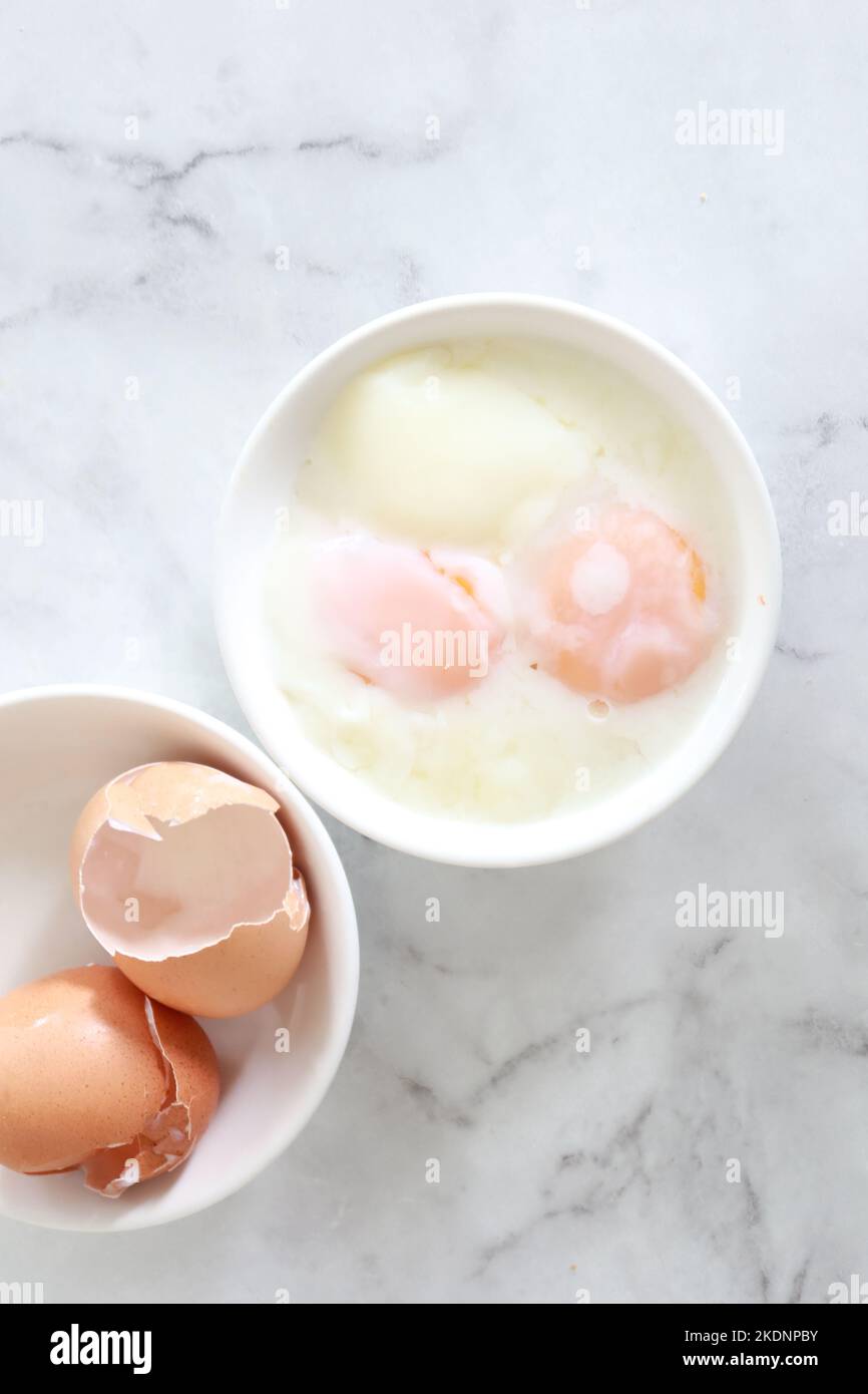 half boiled eggs in the plate close up Stock Photo - Alamy