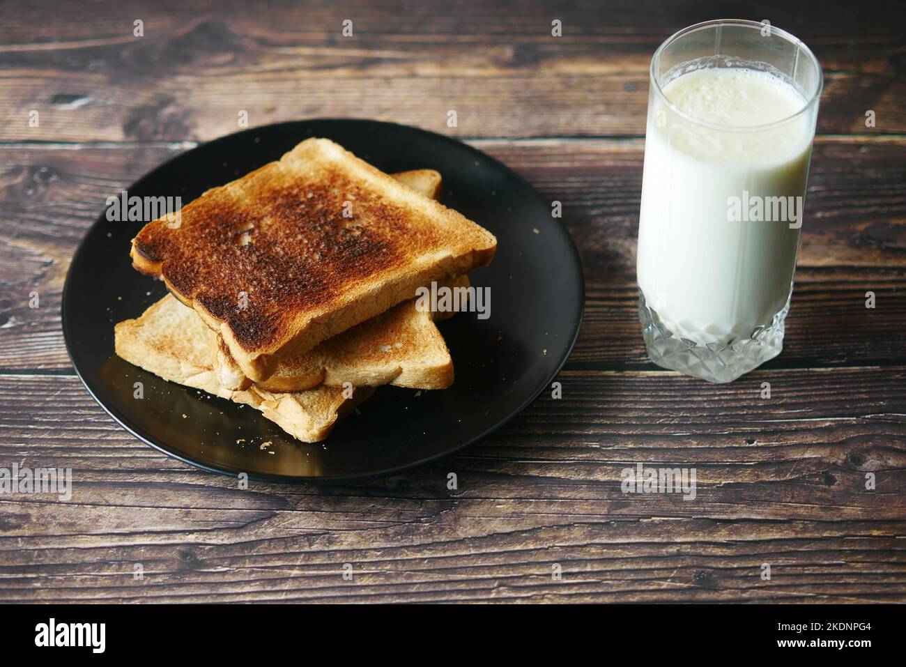 glass of whole cream milk and bread on table Stock Photo - Alamy
