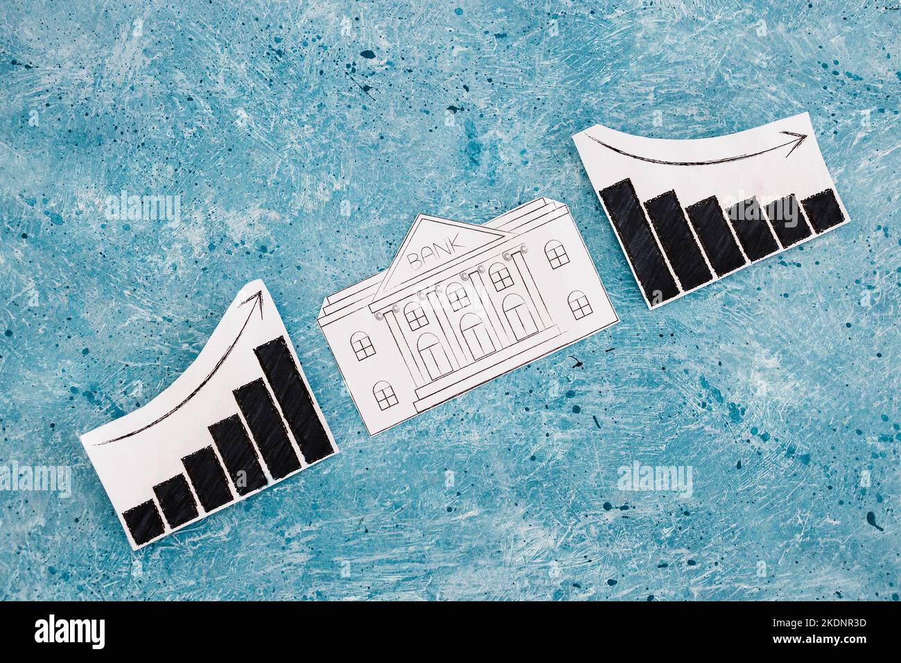 bank icon in between graphs with stats going up then going down ...