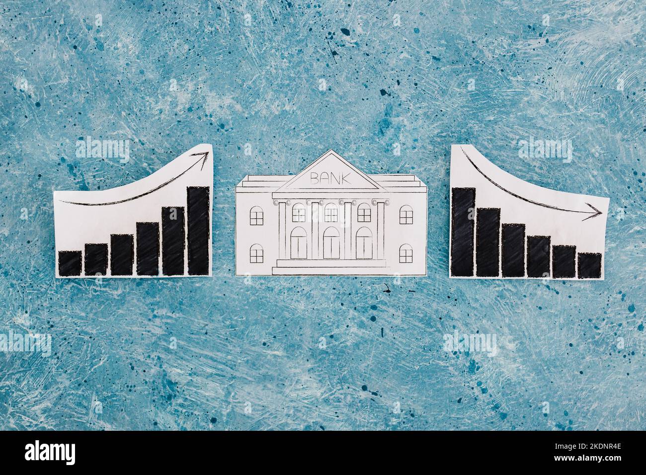 bank icon in between graphs with stats going up then going down ...