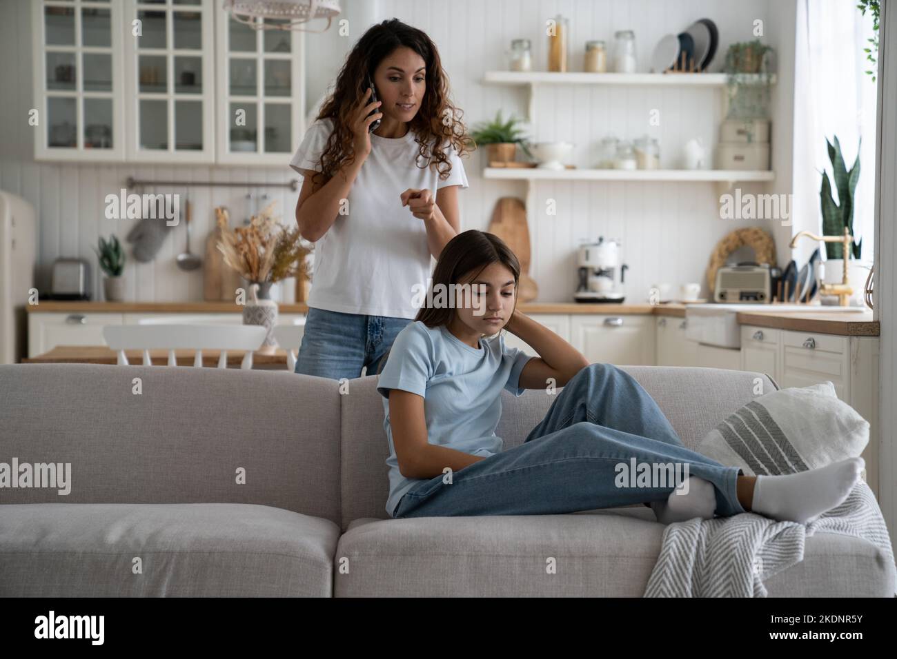 Overbearing mother talking with school teacher by phone, getting angry ...