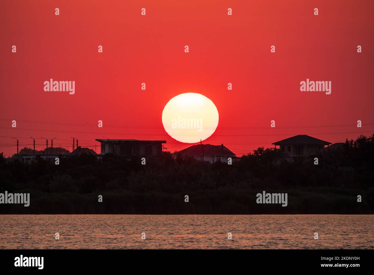 The sun goes down over a lake. Dramatic Sunset Sky Stock Photo - Alamy