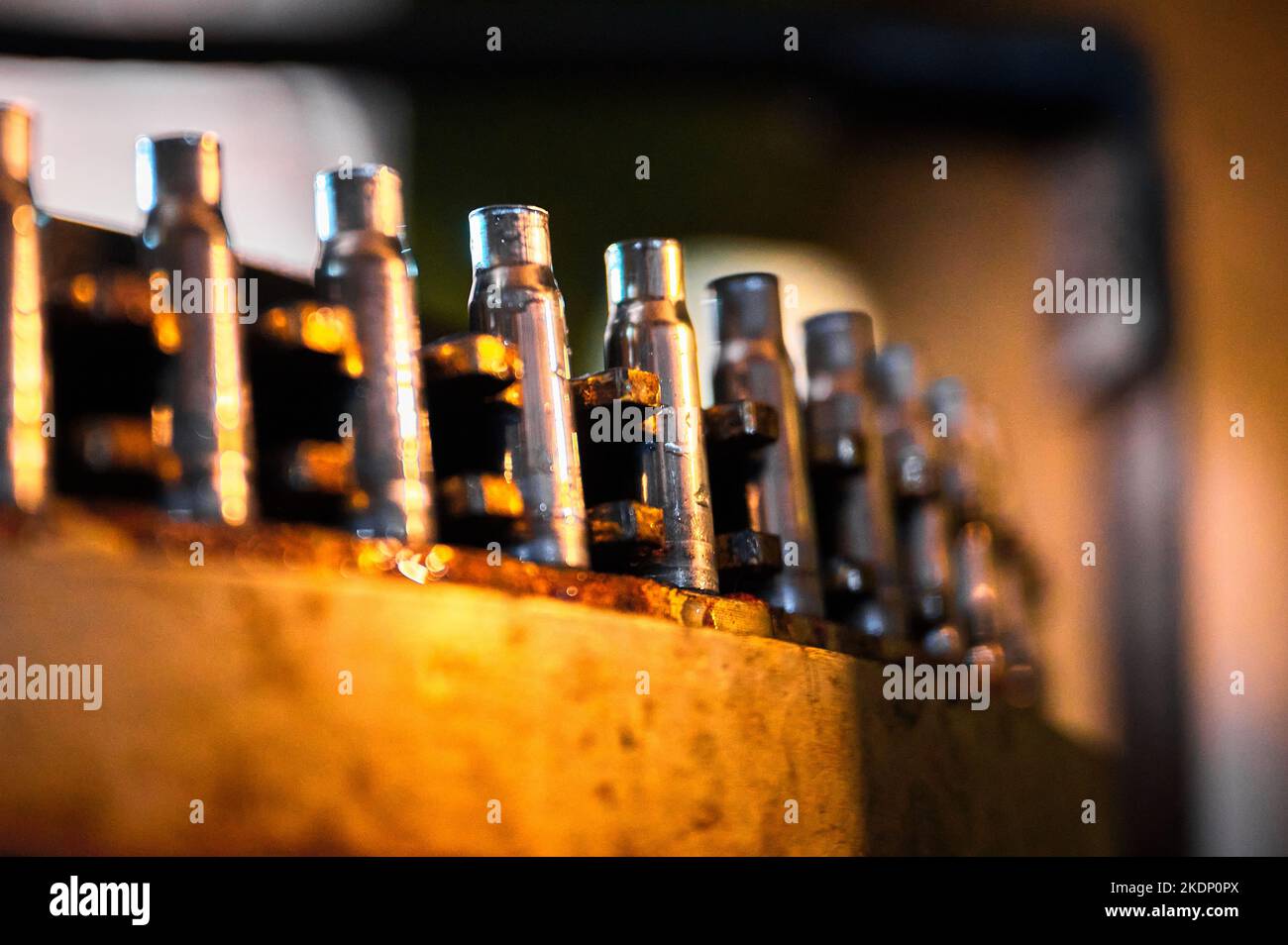Shell casings transported by vintage equipment at plant Stock Photo - Alamy