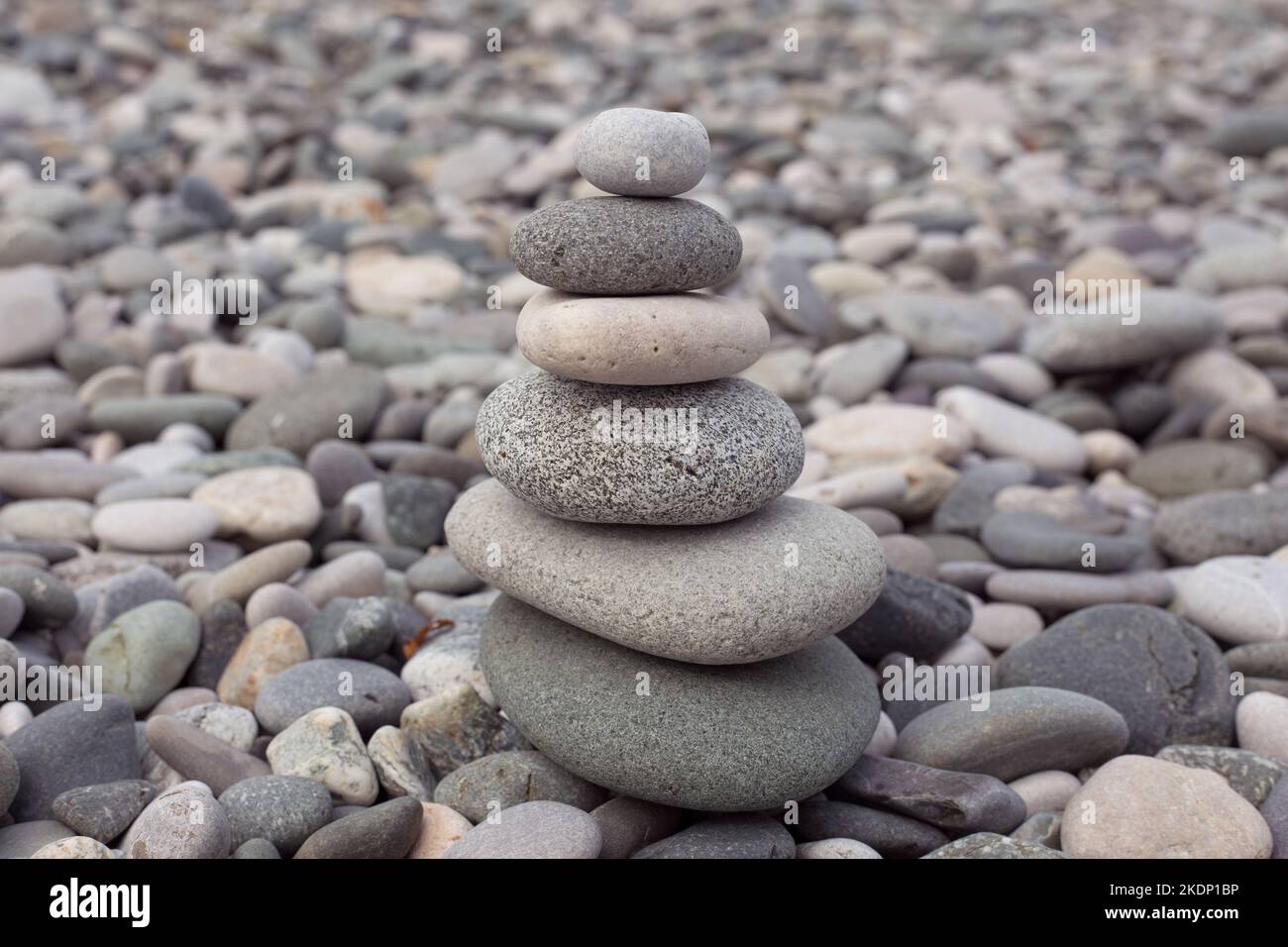 Stone Cairn on Grey Pebble Sea Background. Rock Zen Sculpture Stock ...