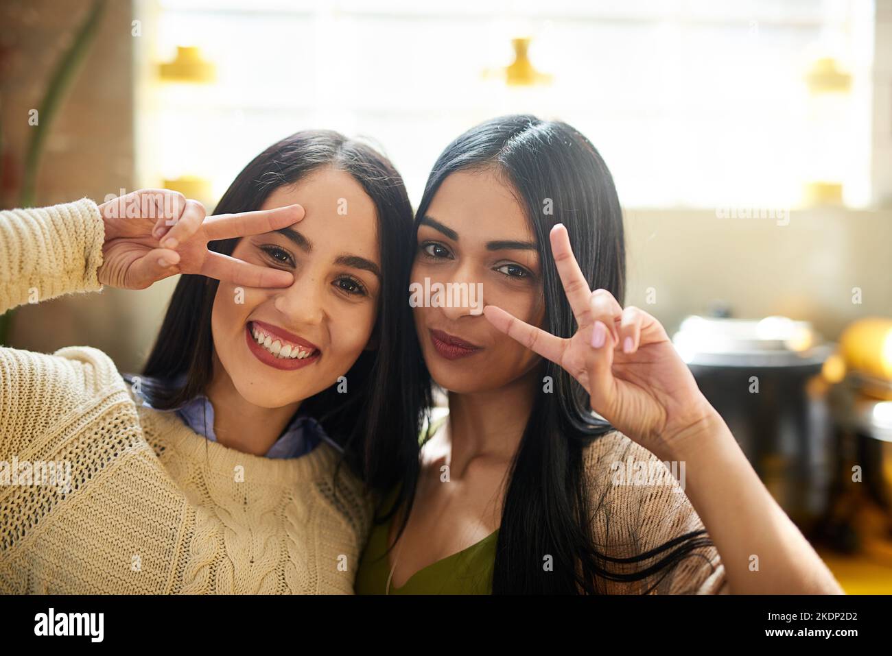 Good vibes and great times. Portrait of two young friends showing the ...