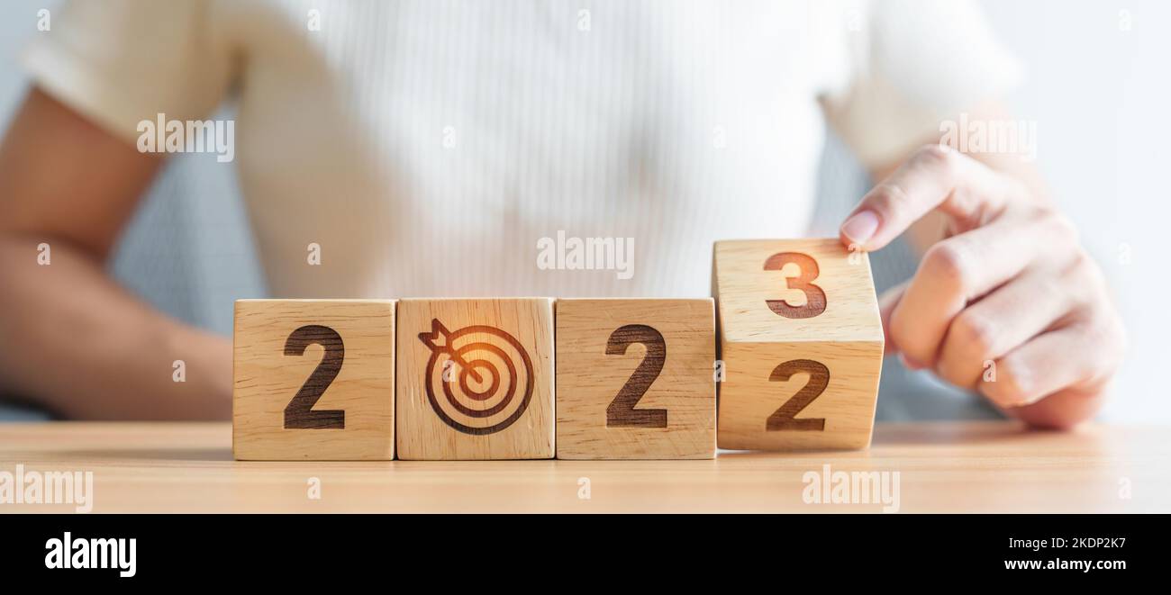 woman hand change 2022 to 2023 block with dartboard icon. Goal, Target ...