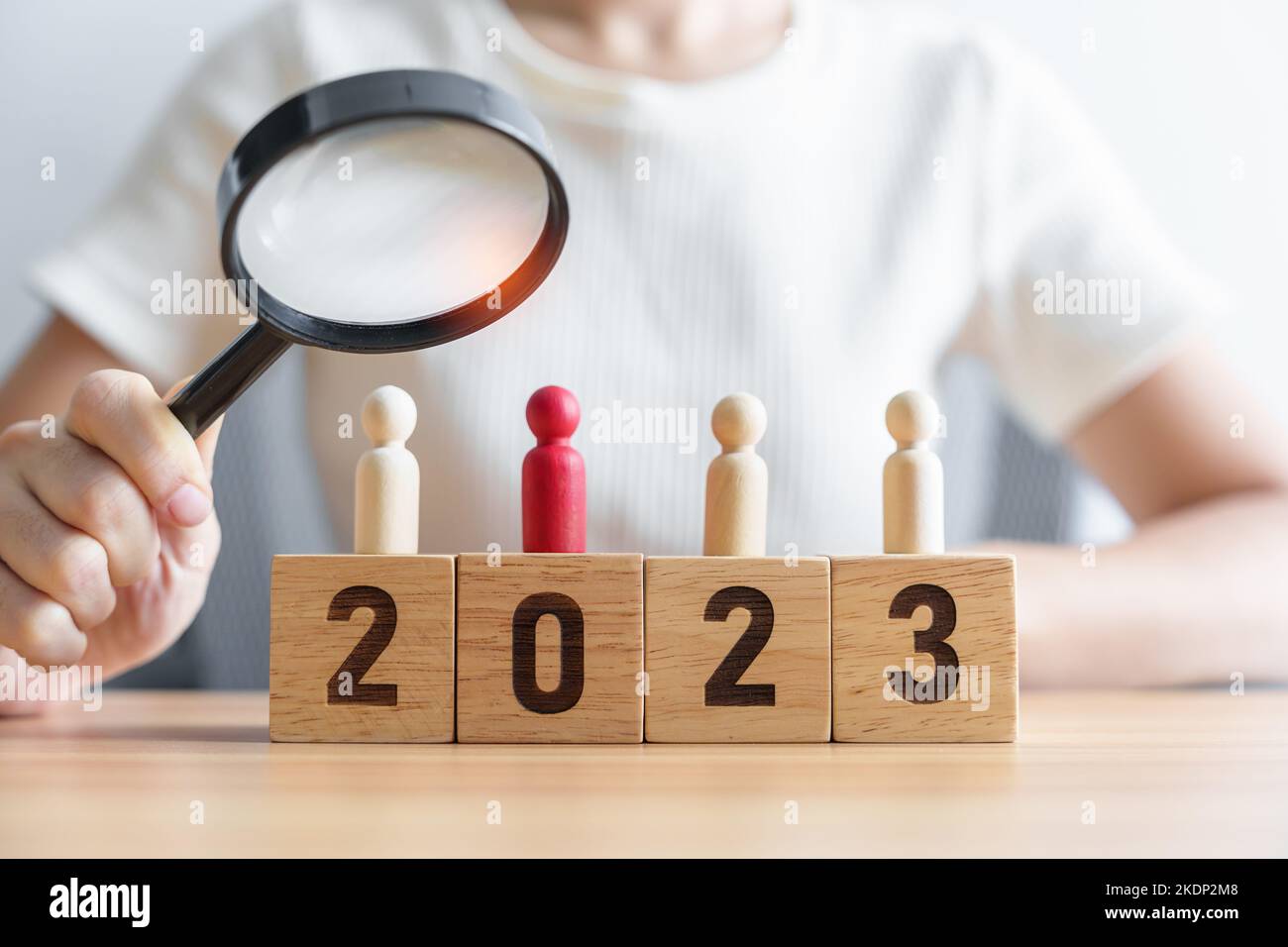 2023 block with magnifying glass and people. hiring, employee ...