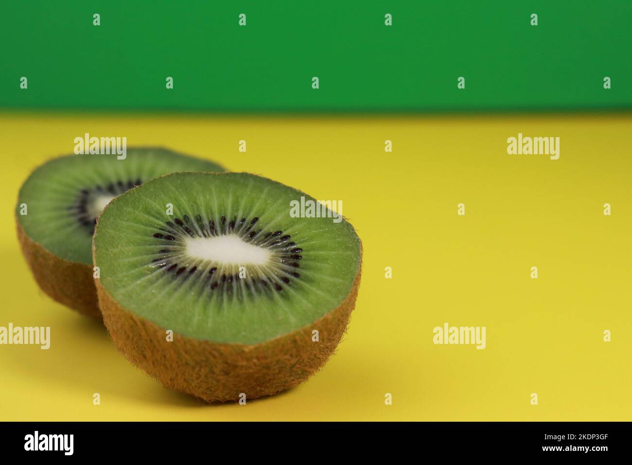 close up of kiwi fruit on yellow background Stock Photo - Alamy