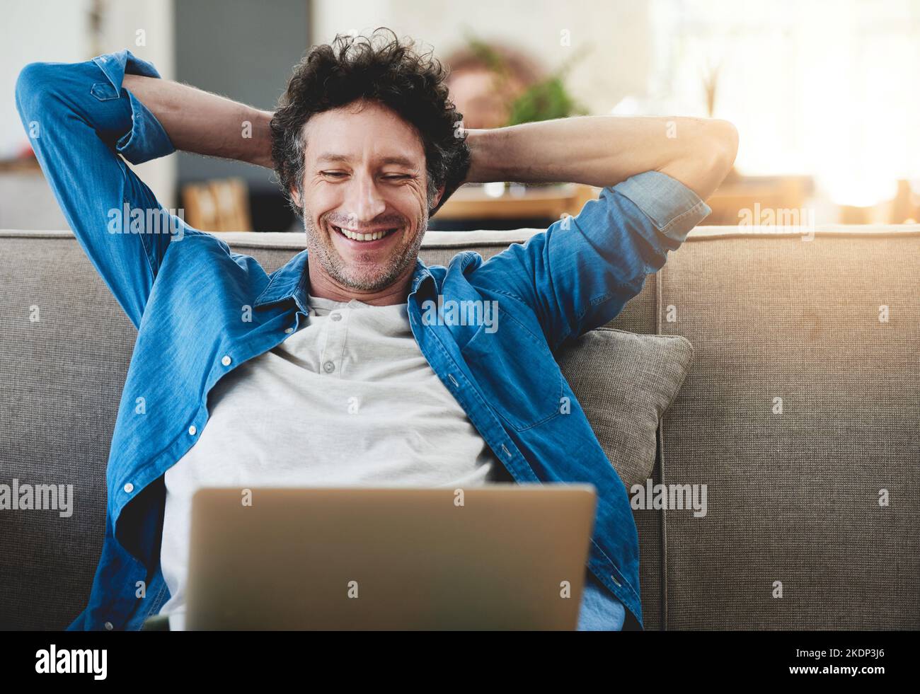 Catching up on his favourite series. a happy bachelor relaxing on the ...