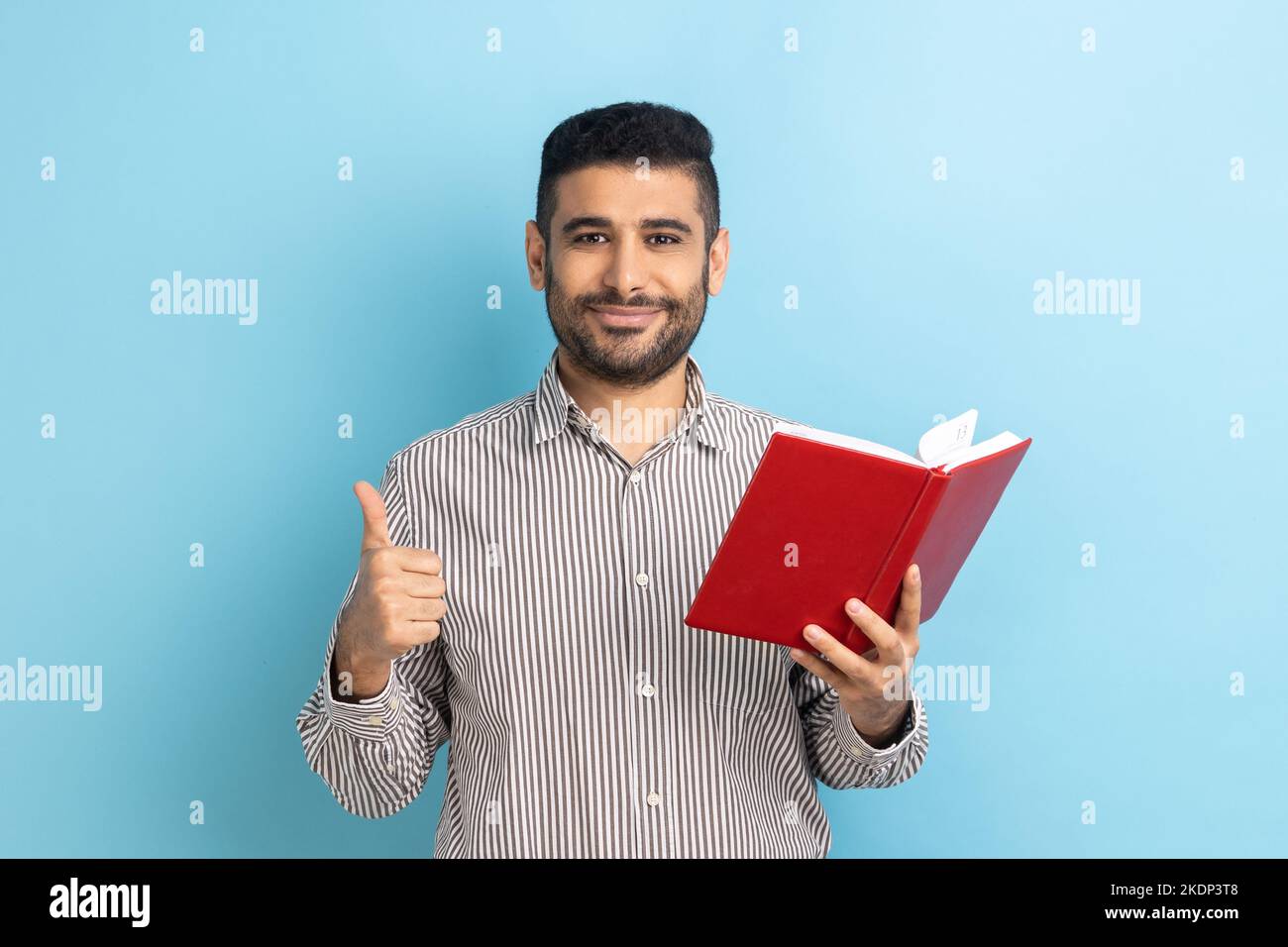 Portrait of smiling happy bearded businessman showing thumbs up gesture ...