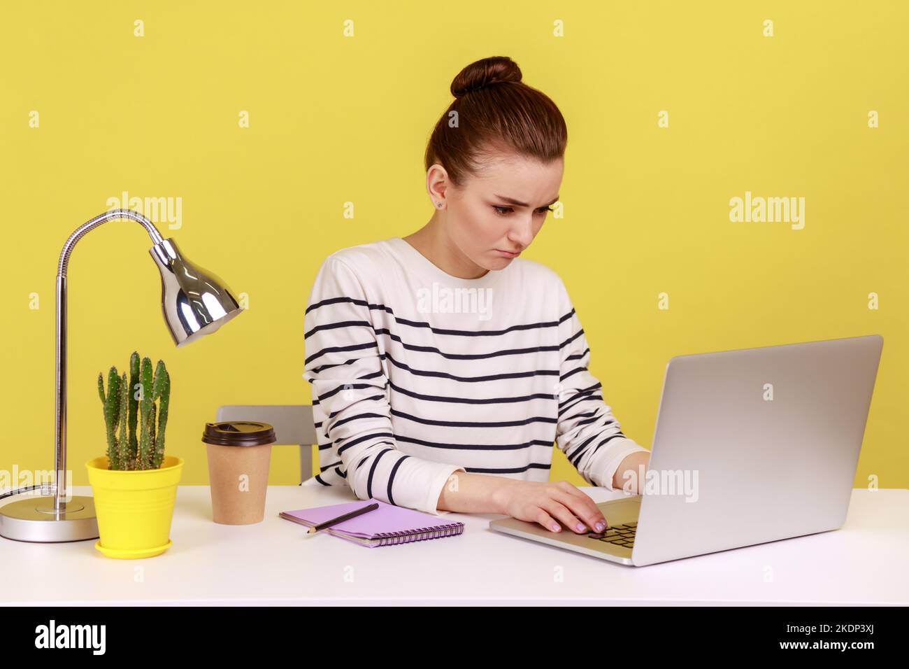 Sad unhappy woman office manager sitting at workplace looking at laptop ...