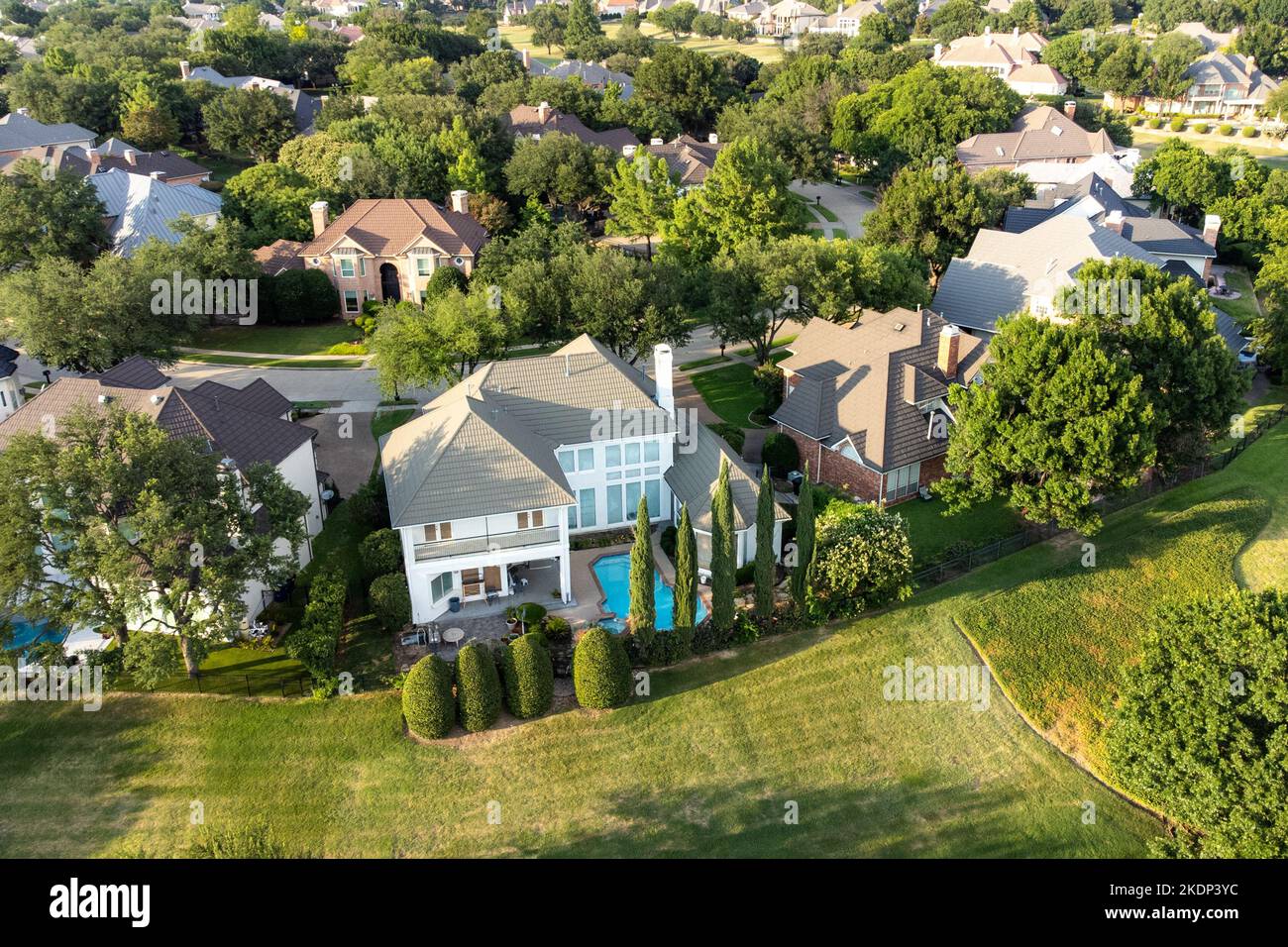 Aerial drone view of luxury mansions with swimming pools surrounded by ...