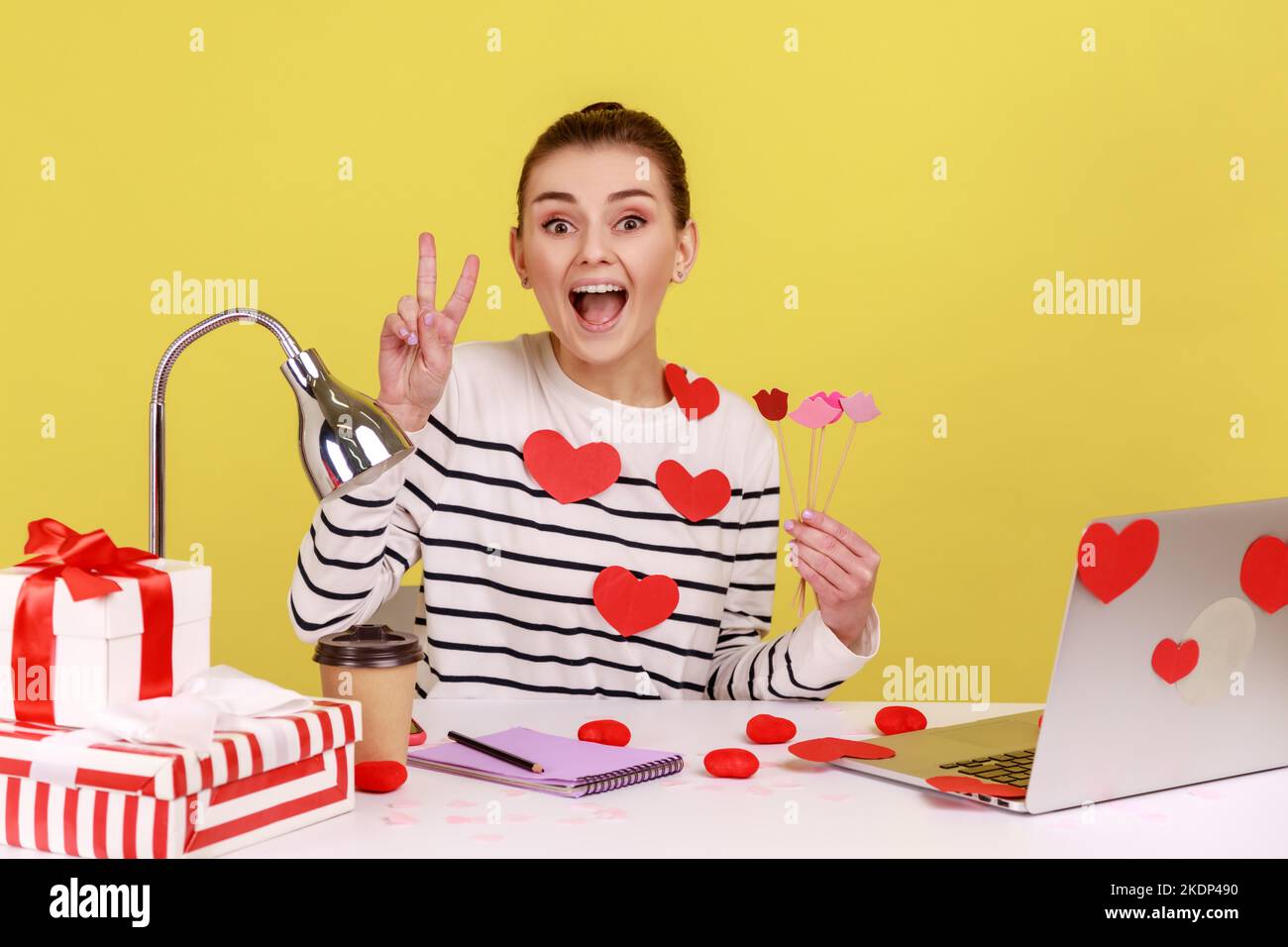 Funny excited festive woman office manager sitting on workplace with ...