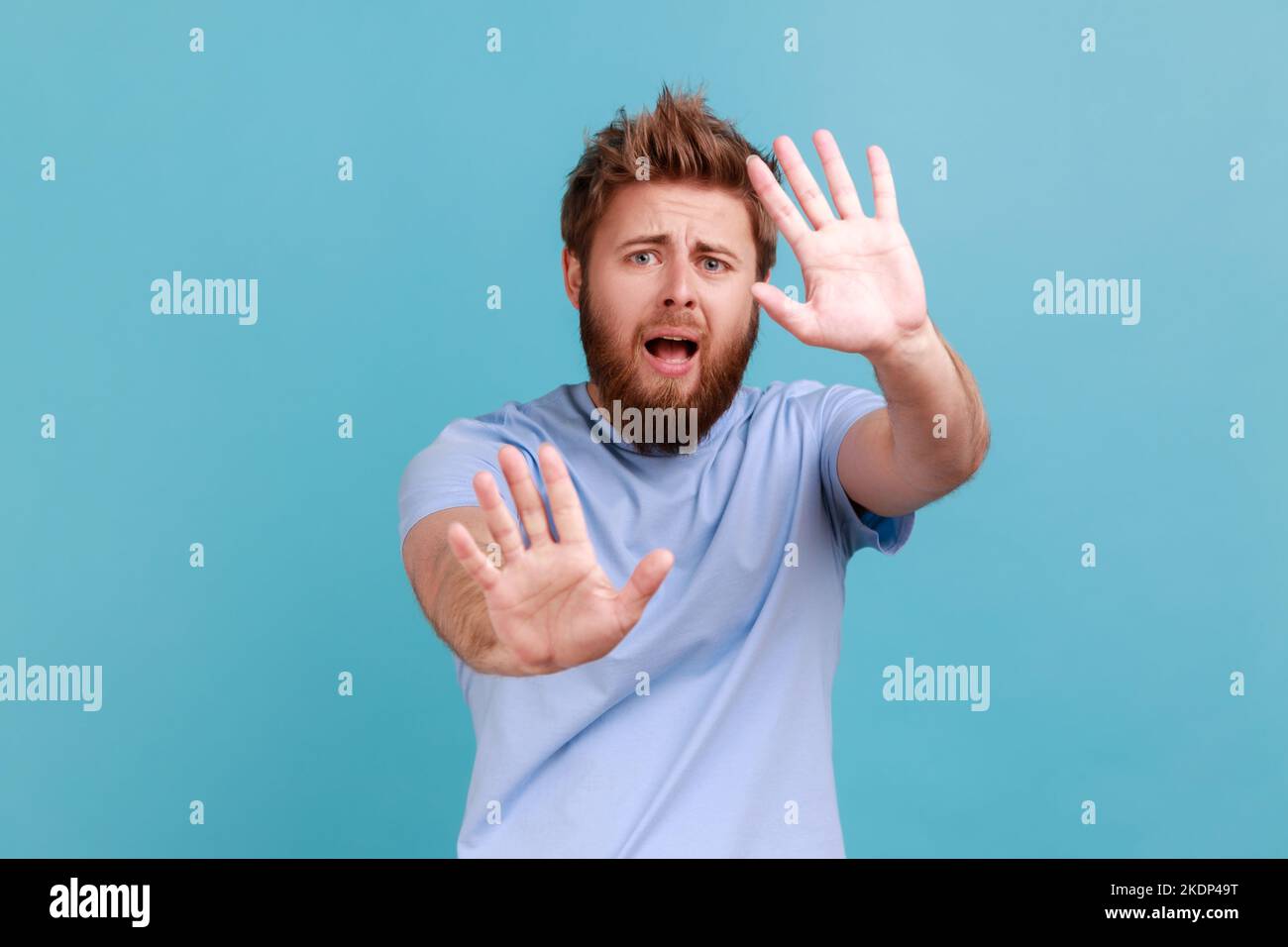 Portrait of shocked scared unhappy young bearded man screaming in ...