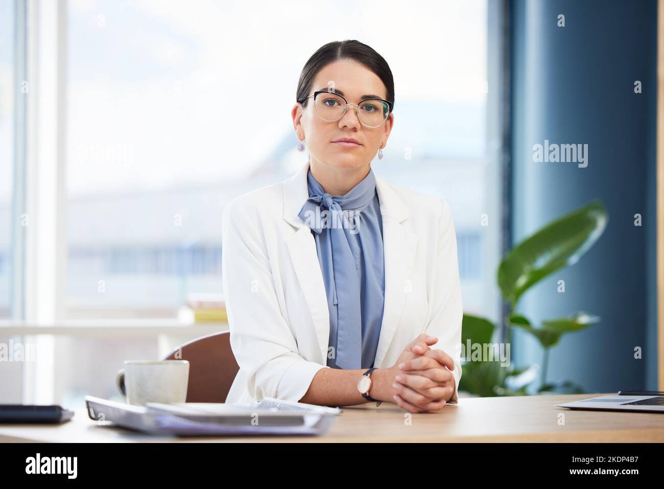Portrait of doctor working in her office at hospital with healthcare ...