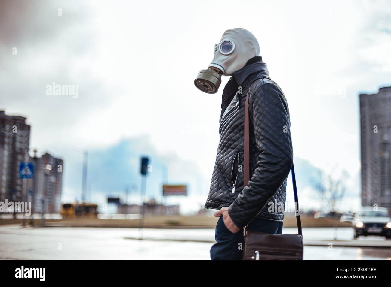 casual young man in a gas mask on a city street. photo with a copy ...