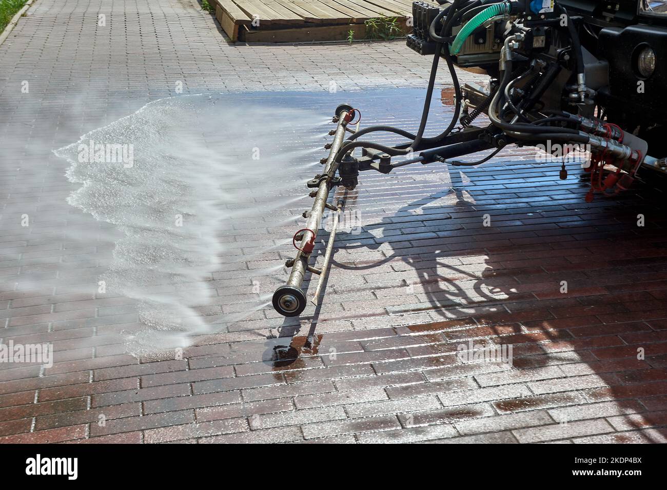 A special machine washes city paths and roads with water Stock Photo ...