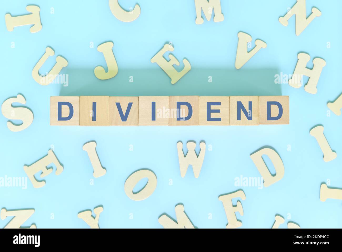 Dividend concept in finance and investing. Word typography on wooden ...