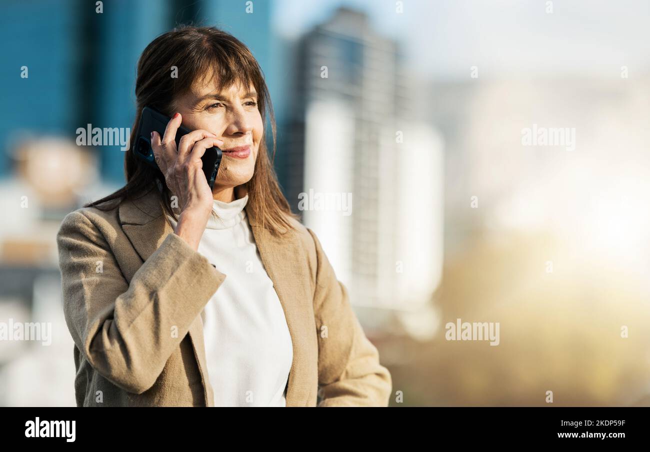 Phone call, city and senior business woman standing in street talking ...