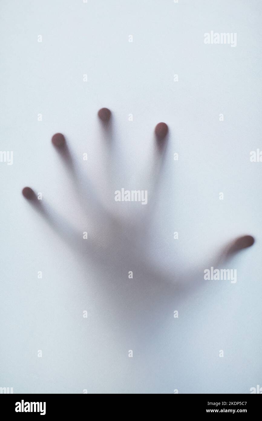 Reaching out into the void. Defocussed shot of a single hand reaching ...