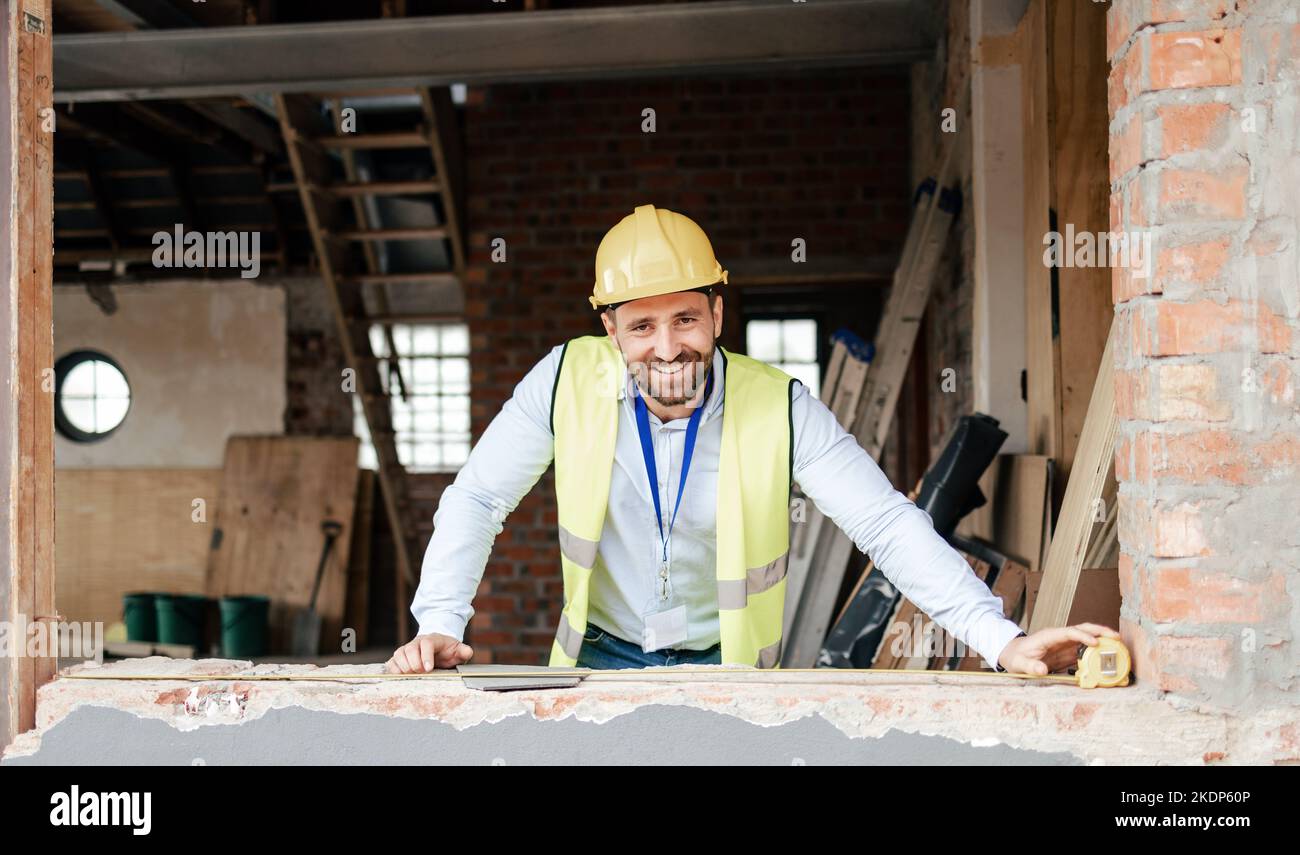 Architect, building and smile on construction site for project ...