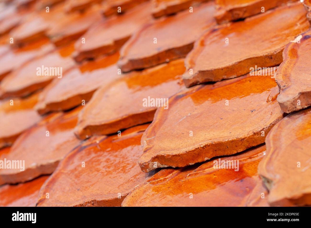 Orange clay tiles overlapping each other on the roof. Geometric pattern ...