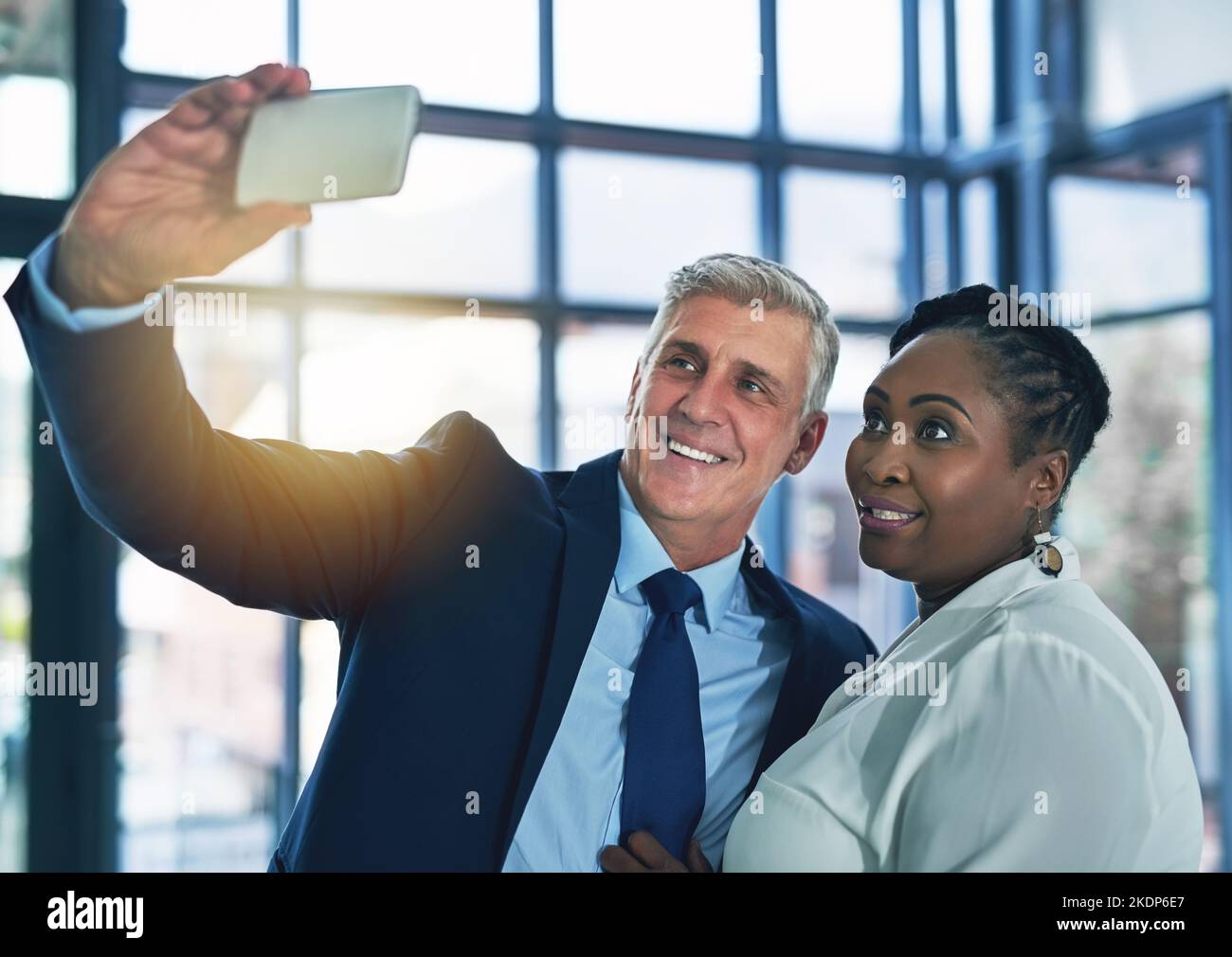 Some colleagues become friends. two happy businesspeople posing for a ...