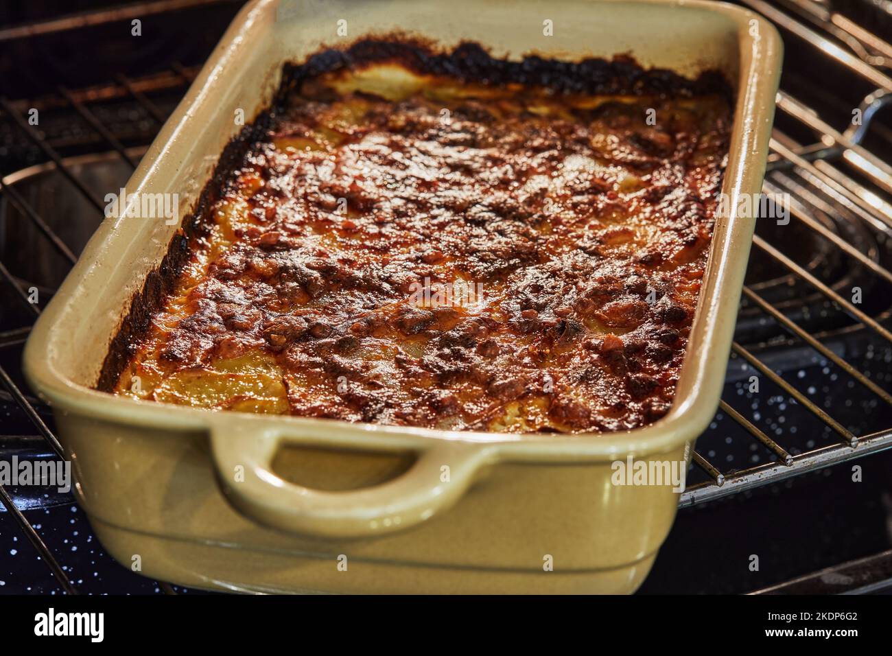 Potato and sweet potato gratin with Provence herbs is baked in the oven ...