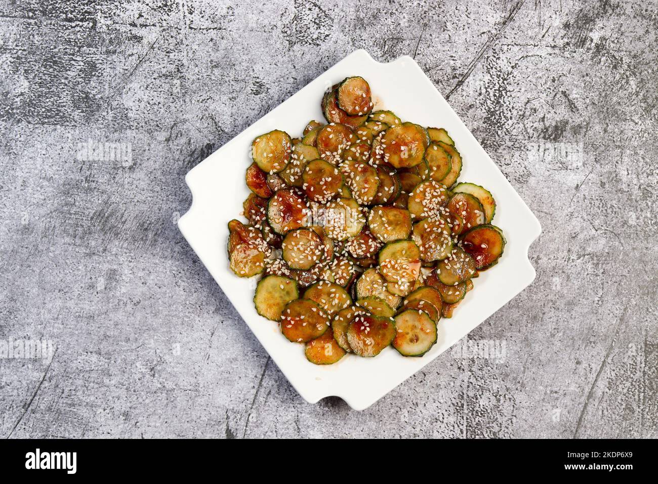 Sunomono - Japanese Cucumber Salad with sesame seeds on a white square ...