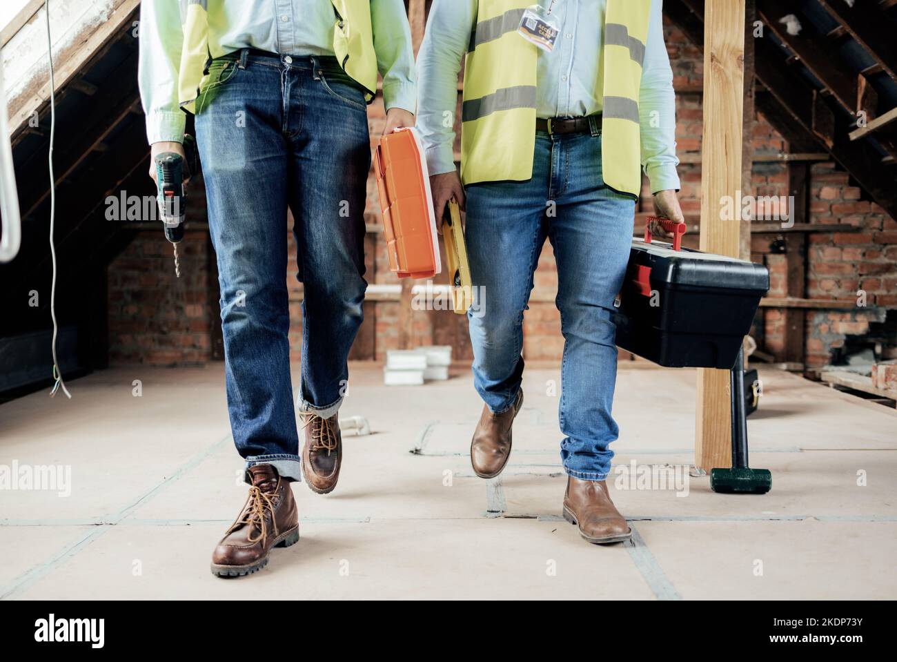 Construction, team and legs of engineers walking on the building site ...