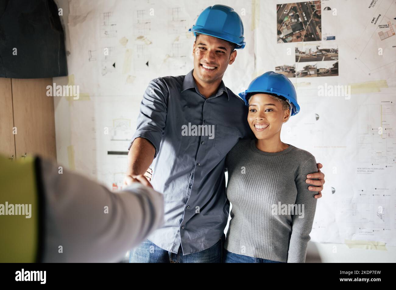 Handshake, construction and couple consulting, planning and doing ...