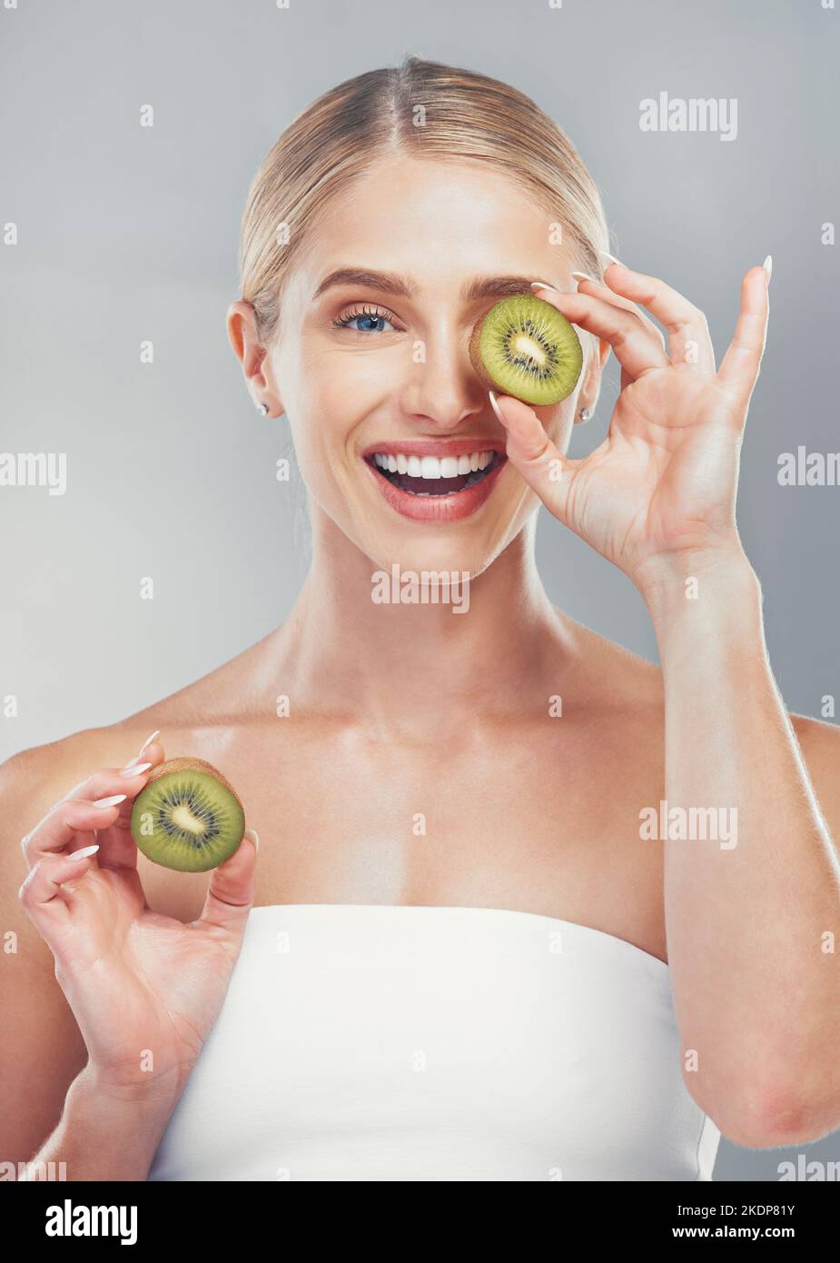 Happy studio portrait, woman with kiwi for skincare wellness, health ...