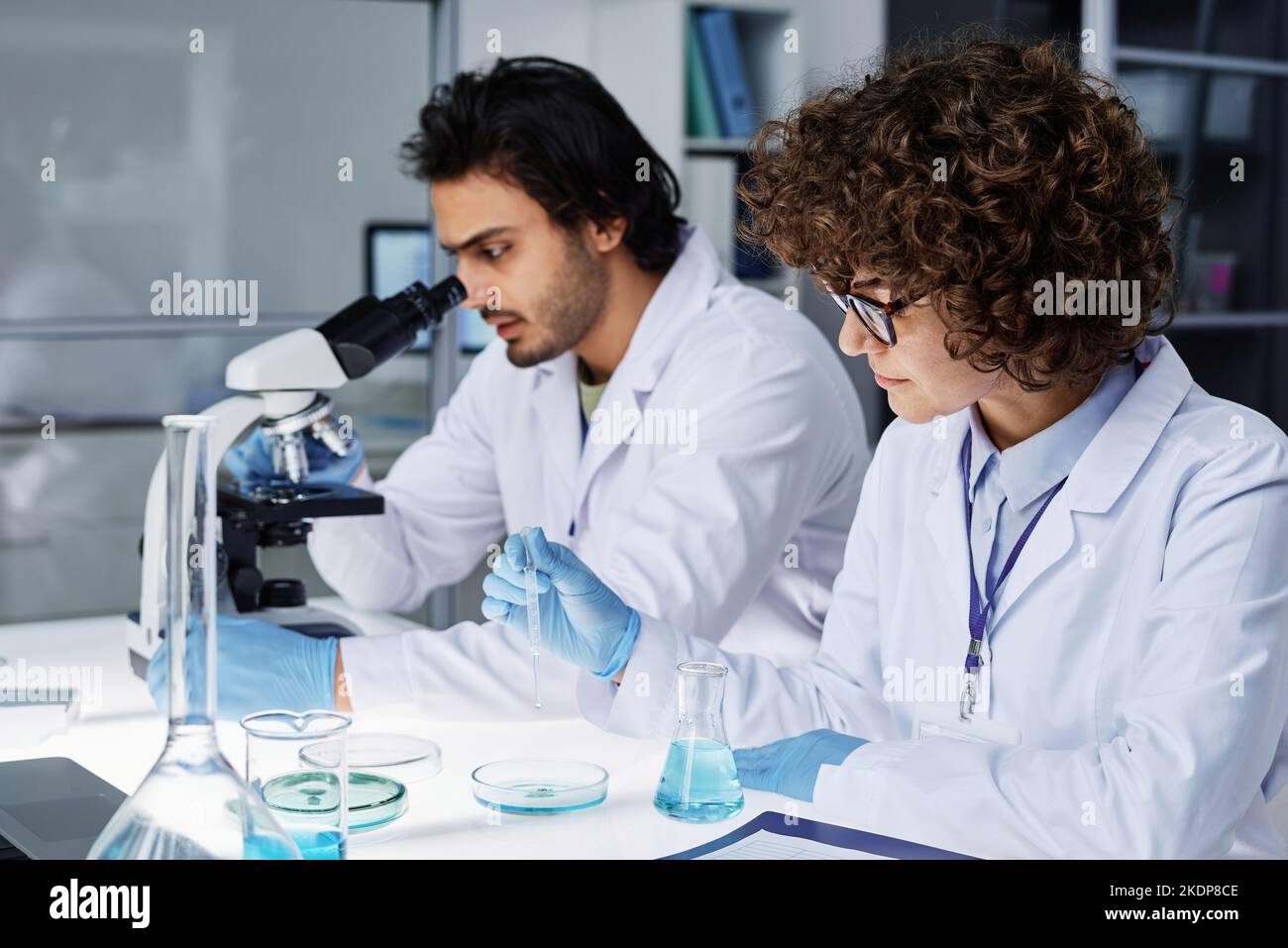 Young clinicians working in team over new scientific experiment while ...