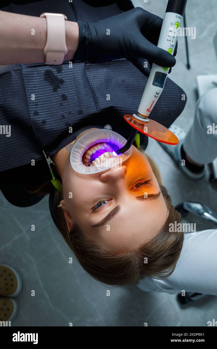 The orthodontist puts metal braces on the patient's teeth. Orthodontic ...