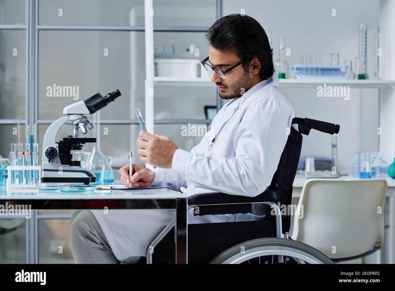 Young male clinician with disability describing characteristics of new ...