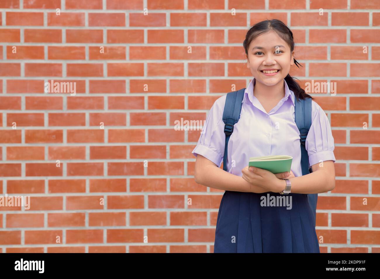 Thai asian school girl teen happy smile in uniform handle book and ...