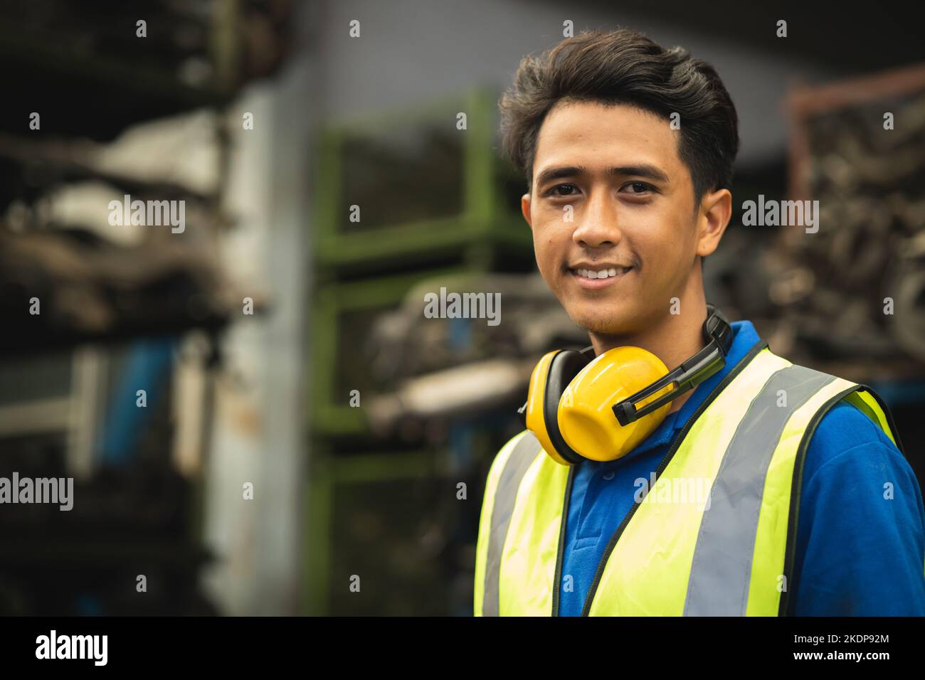portrait young male worker engineer working in heavy industry with ...