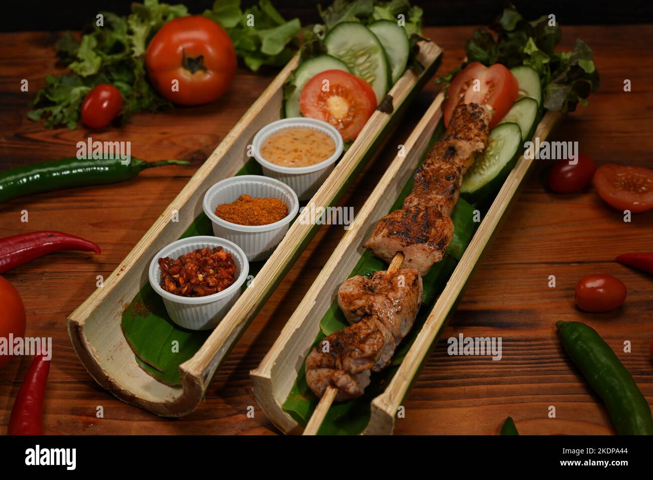Grilled chicken meat in bamboo barrel plat served with Sichuan pepper ...