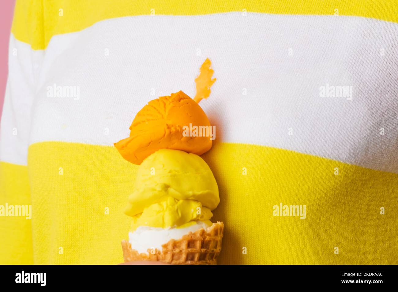 Close up an ice cream cone with three scoops of different flavor ...