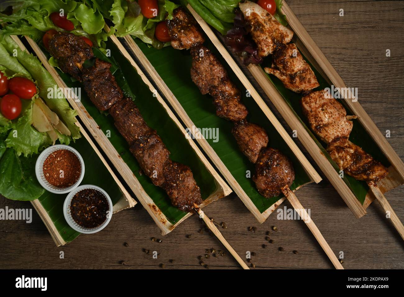 Delicious grilled meat with Sichuan pepper on banana leaf. Mala Chinese ...