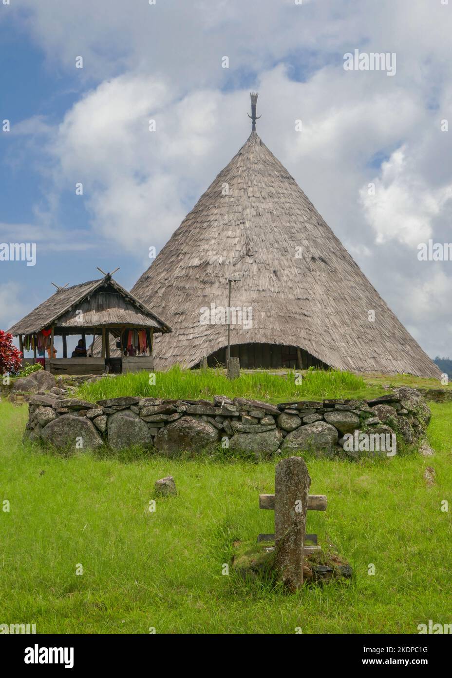 Beautiful traditional house with grave and ritual area in foreground ...