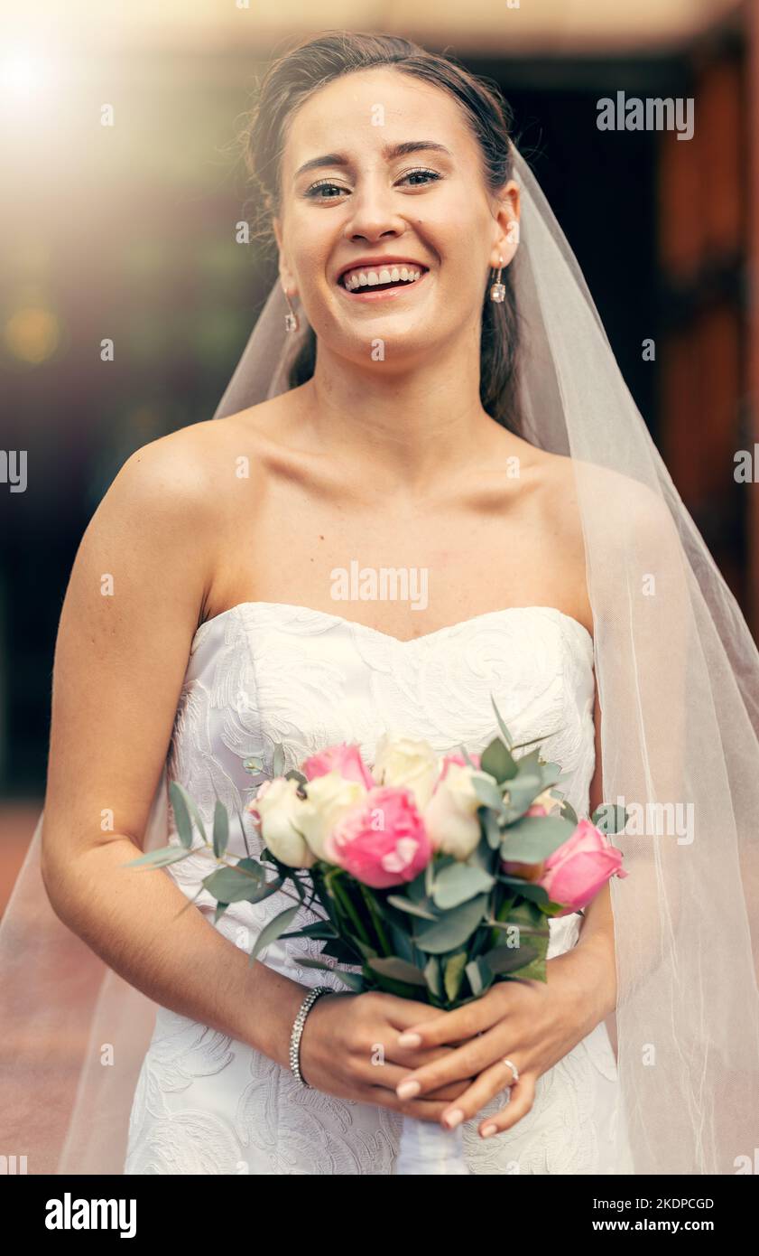 Beauty, fashion and portrait of a happy bride standing outdoor a church ...