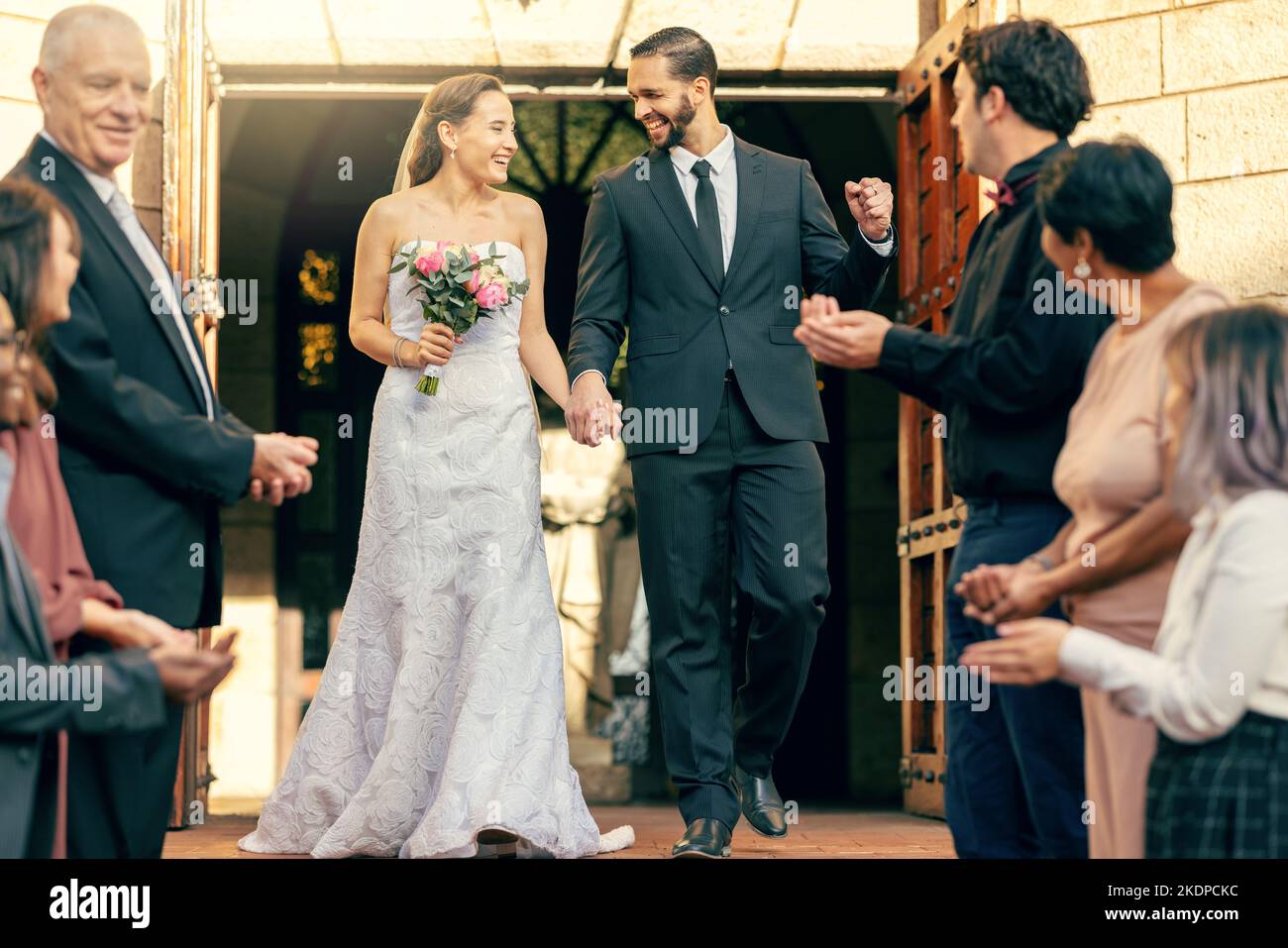 Wedding, man and woman celebrating their love by church after a ...