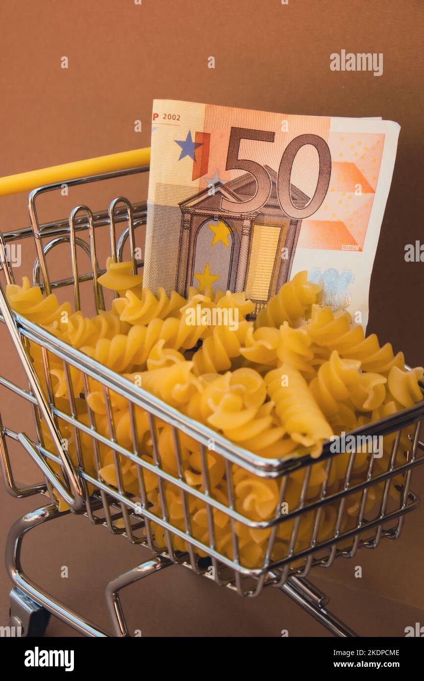 Shopping trolley cart Filled With Pasta with 50 euro paper money ...