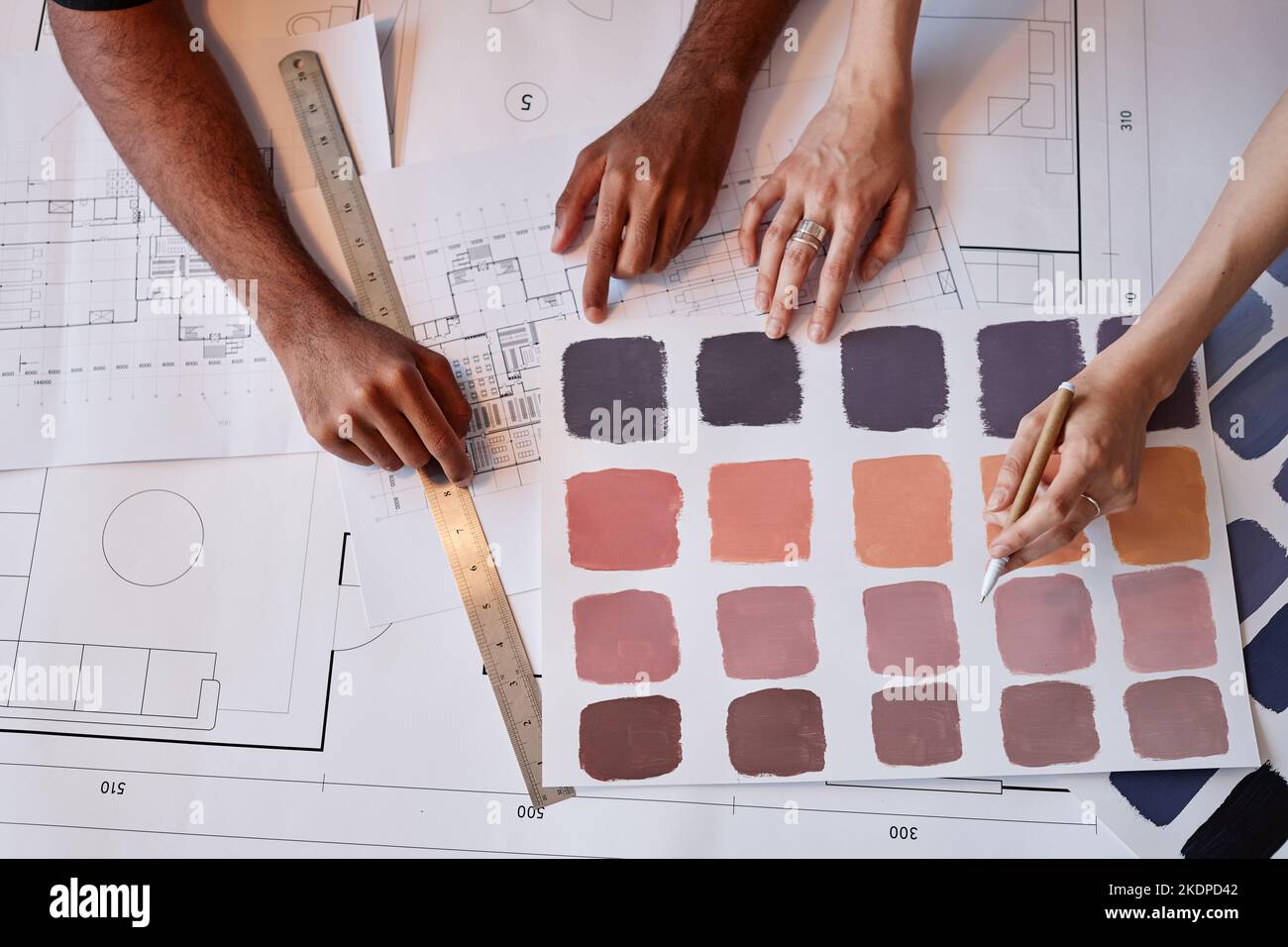 Top view of two architects working on color choice for interior design ...