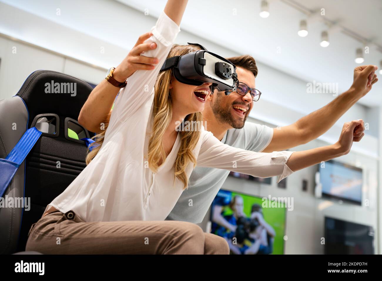 Couple enjoying with VR goggles at tech store. Shopping virtual reality ...