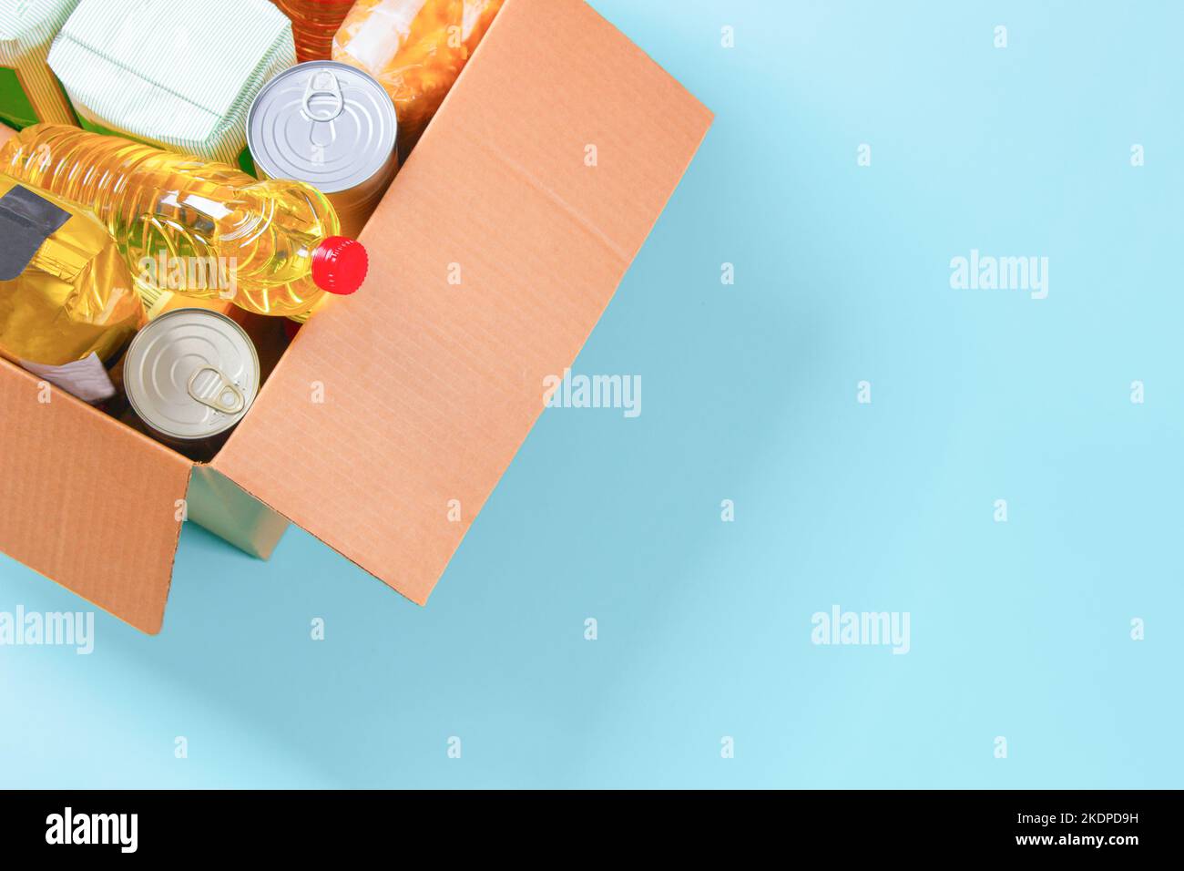 Cardboard box full of grocery products. Donation, charity, food bank ...