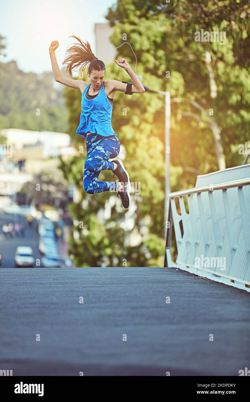 She ran. She trained. She conquered. a young woman jumping in mid air ...